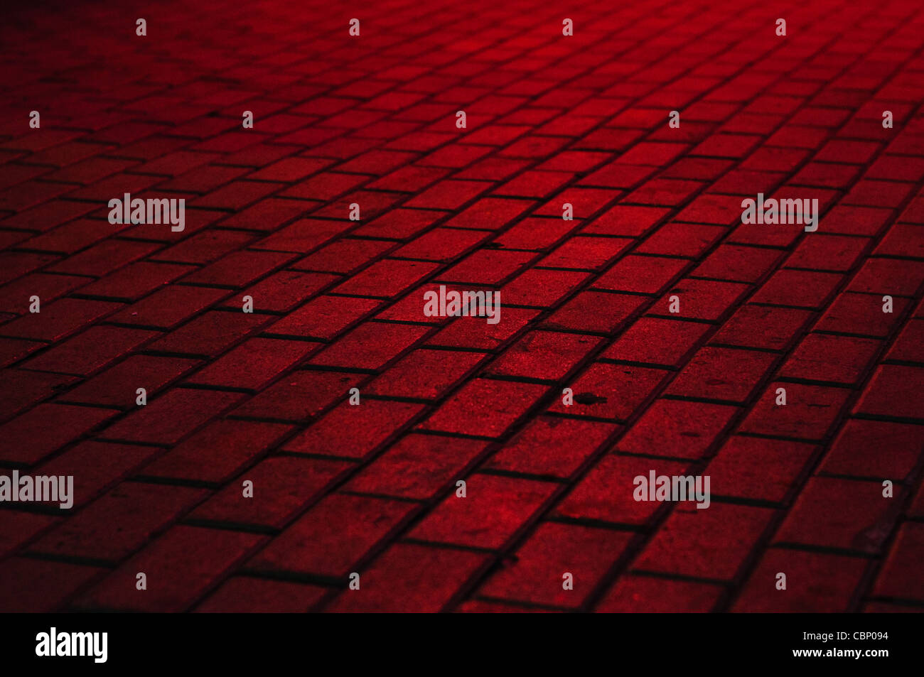 street road made of blocks and lit by red light from electric ad Stock ...