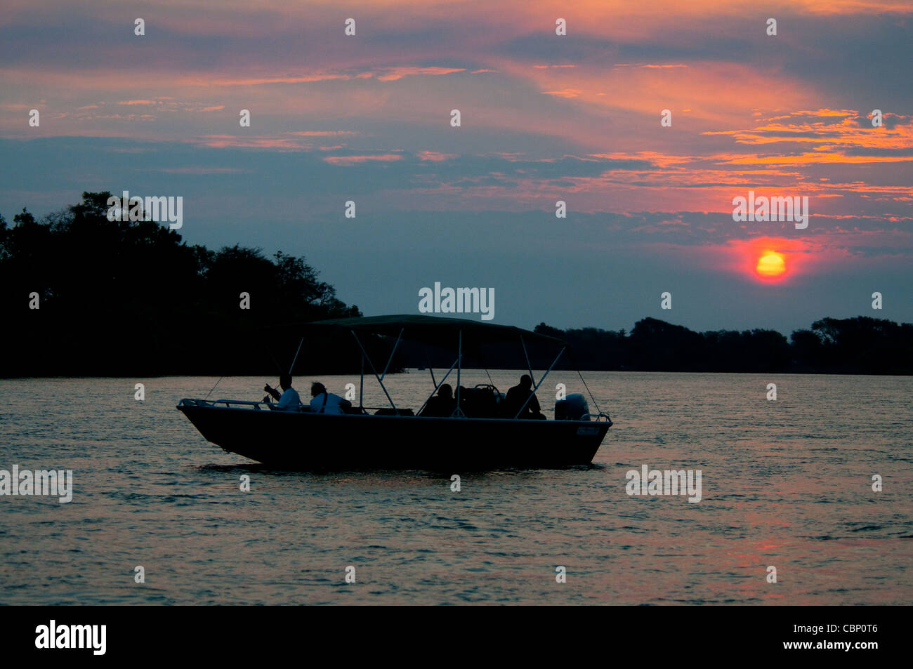 Africa Zambia-Boat on the Zambezi River at sunset Stock Photo - Alamy