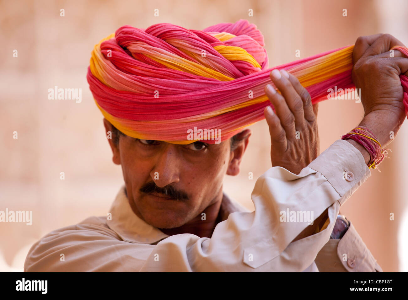 Hindu ceremonial guard putting on Rajasthani turban at Mehrangarh Fort ...