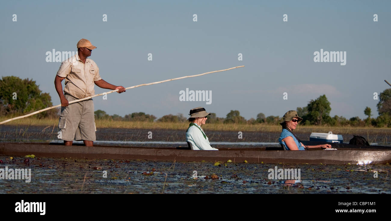 Africa Botswana Okavango Delta-People in Mokoro (dug-out canoe Stock ...