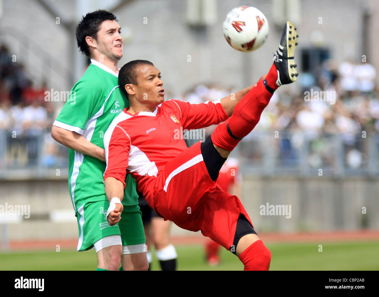 Action from university football match. The player in red performs an ...