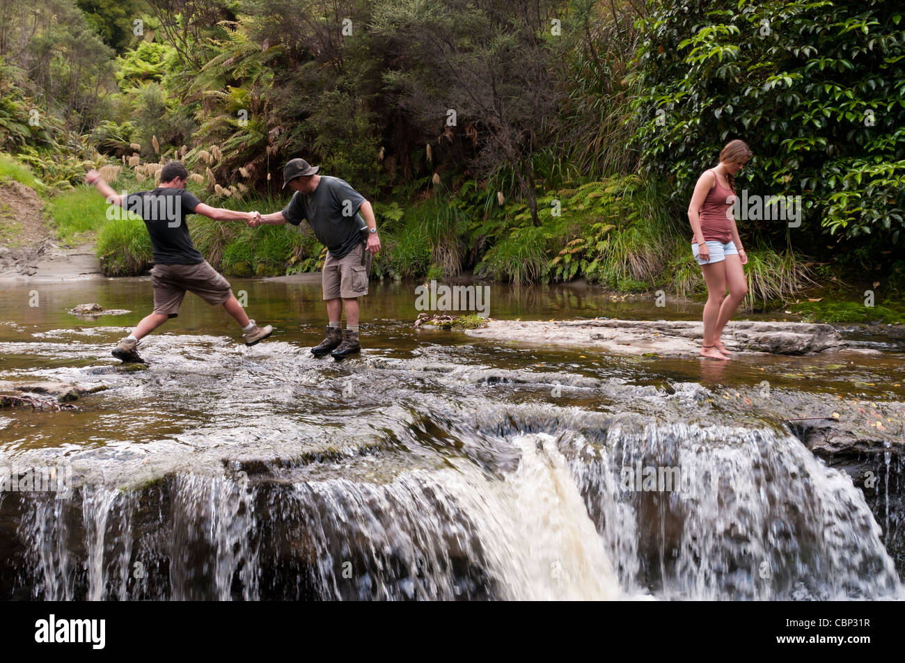Young group of people in there twenties crossing river at top of ...