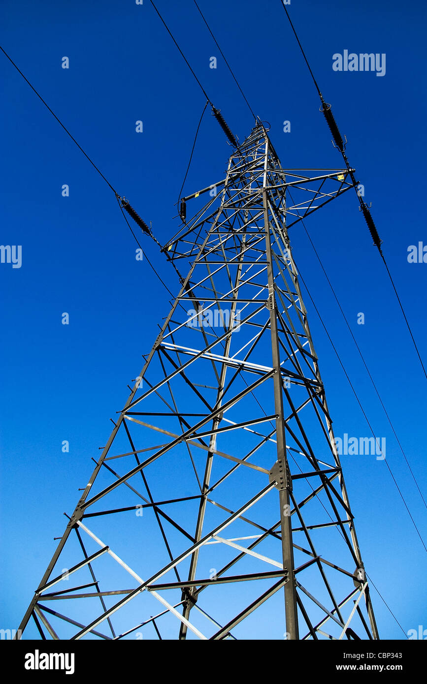 tall electric pylon and cables on blue sky background Stock Photo - Alamy