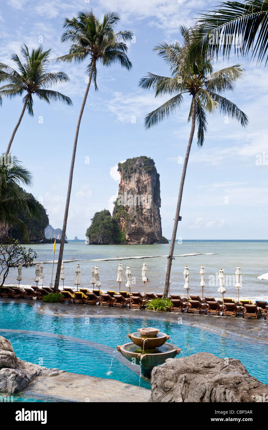 Famous limestone cliffs of Krabi bay overlooking wide sandy beach off ...