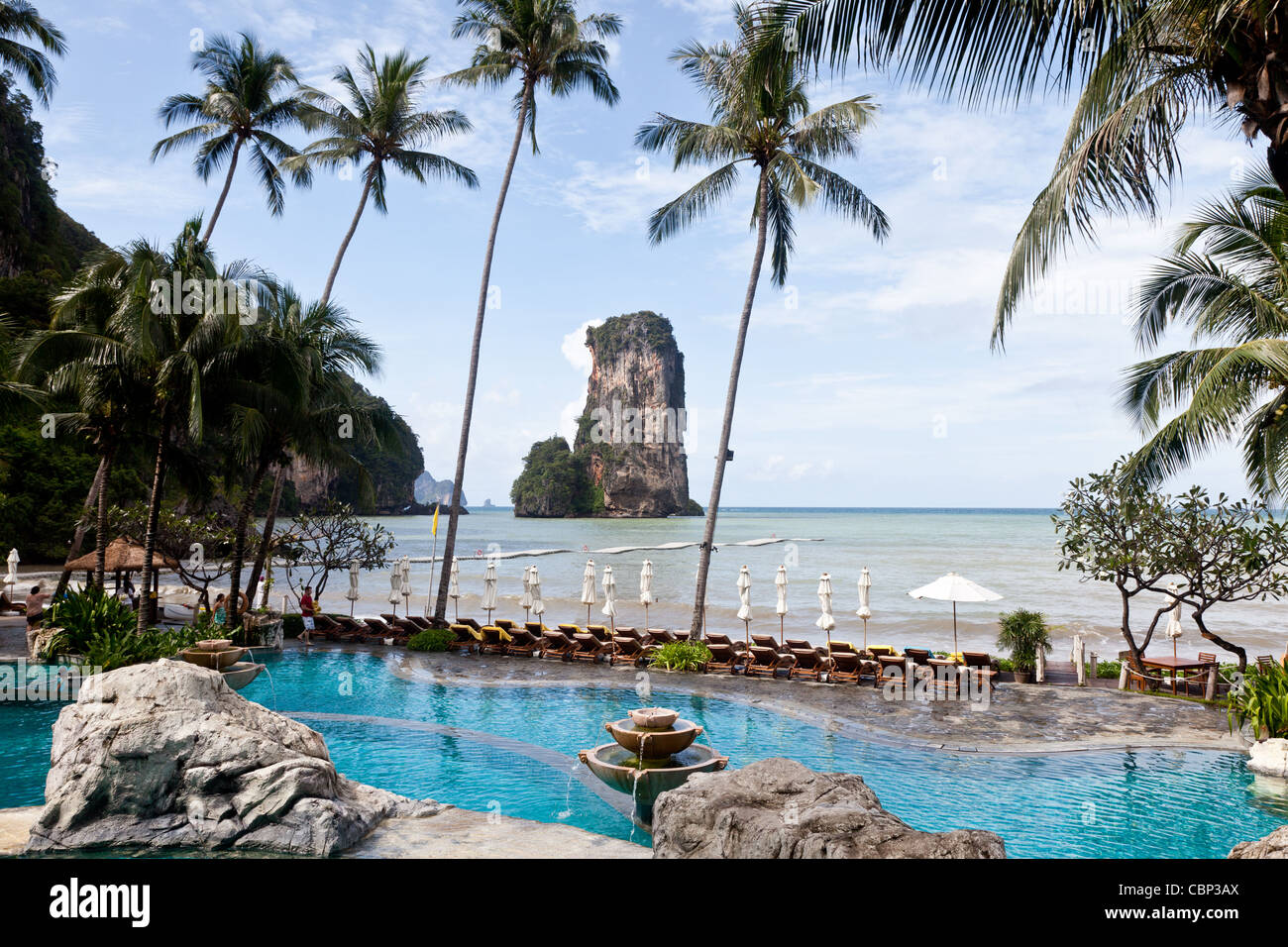 Famous limestone cliffs of Krabi bay overlooking wide sandy beach off ...