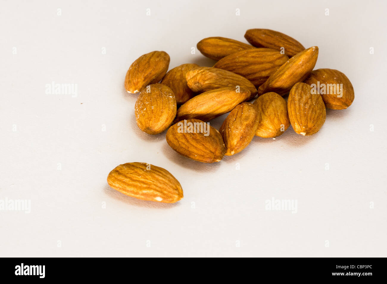 bunch of almonds on the light background Stock Photo - Alamy