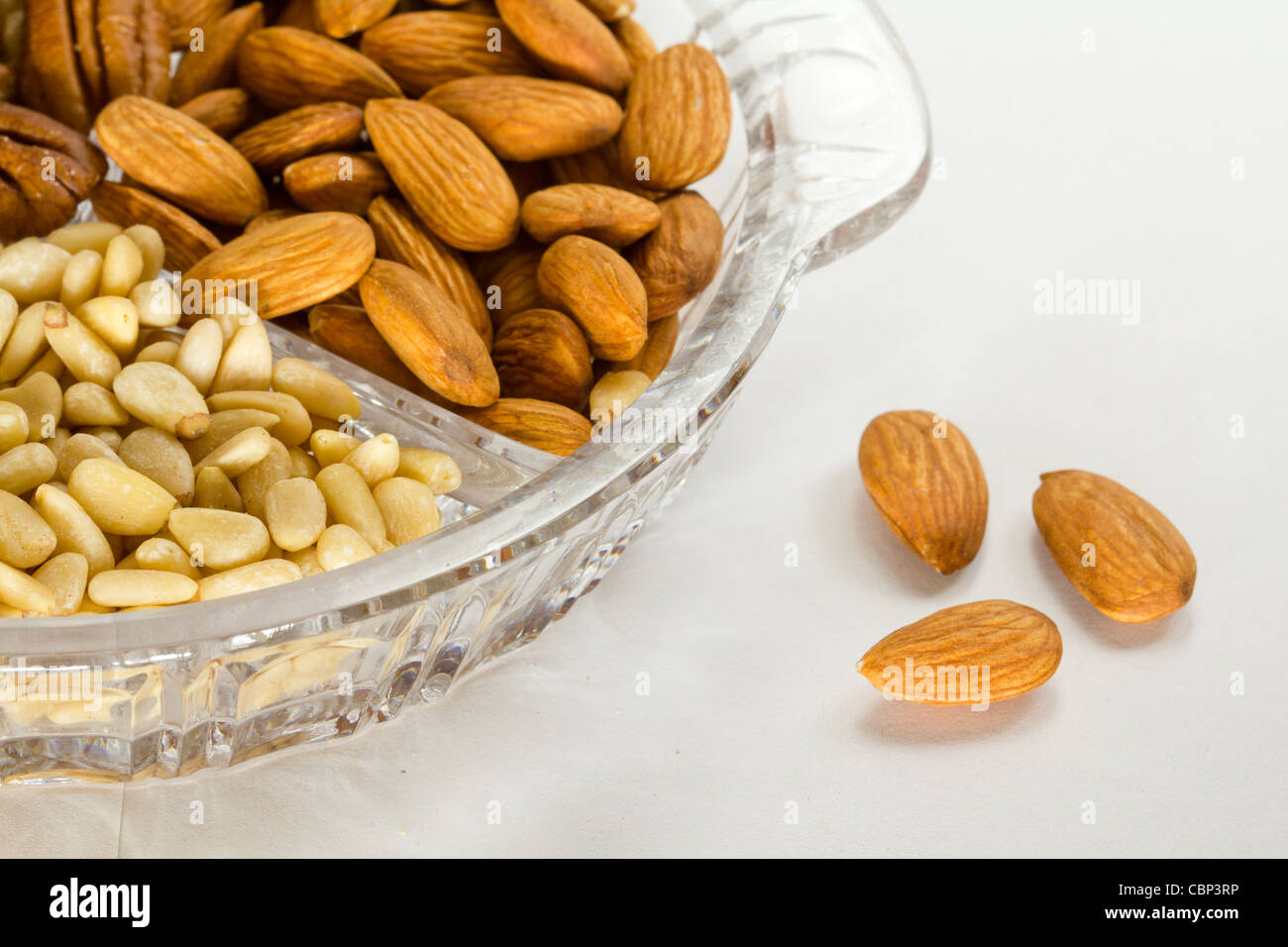 Different kinds of nuts in the crystal bowl Stock Photo - Alamy