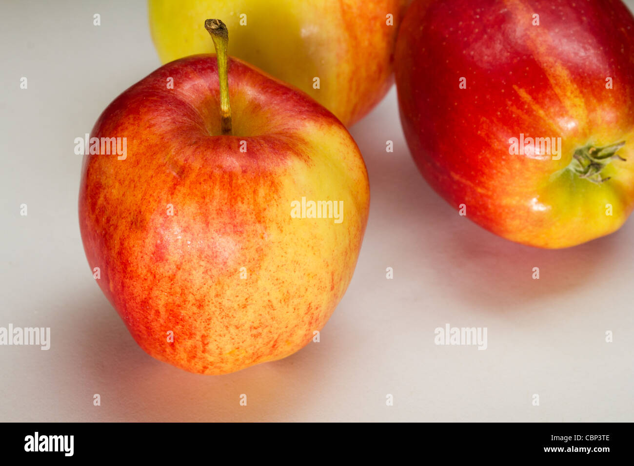 golden red apples against a light background Stock Photo - Alamy