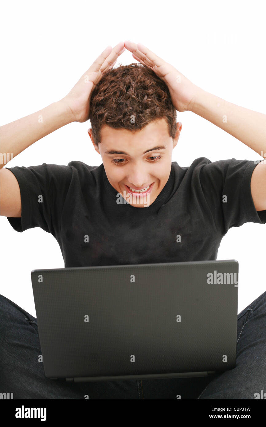 young man shocked with something he see on his laptop computer Stock ...
