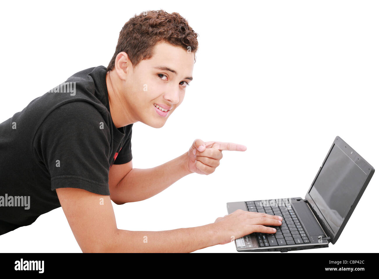 Young student is lying on the floor and looks his laptop. Isolated on ...