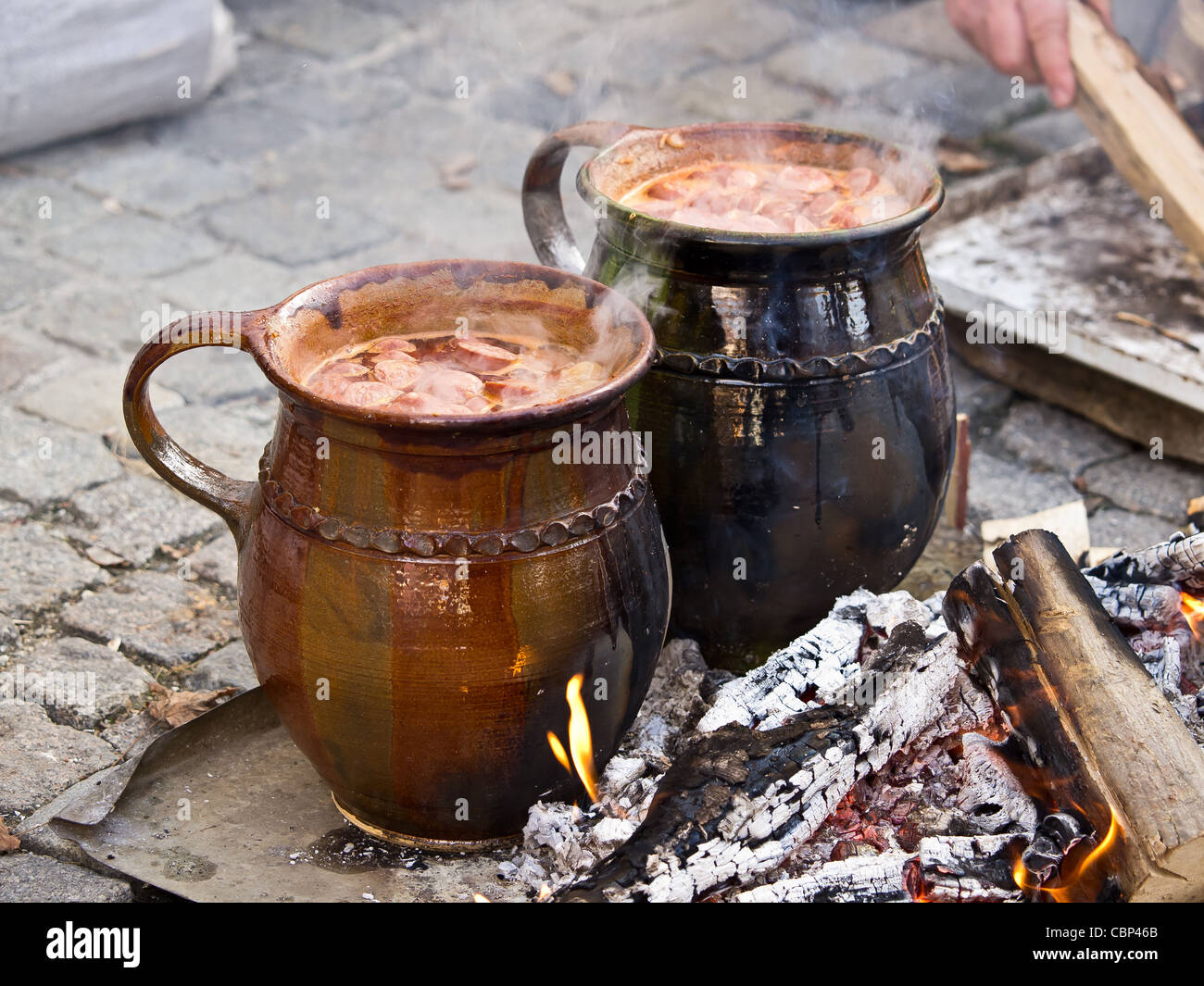 cooking in the ceramic jar on the fire Stock Photo - Alamy