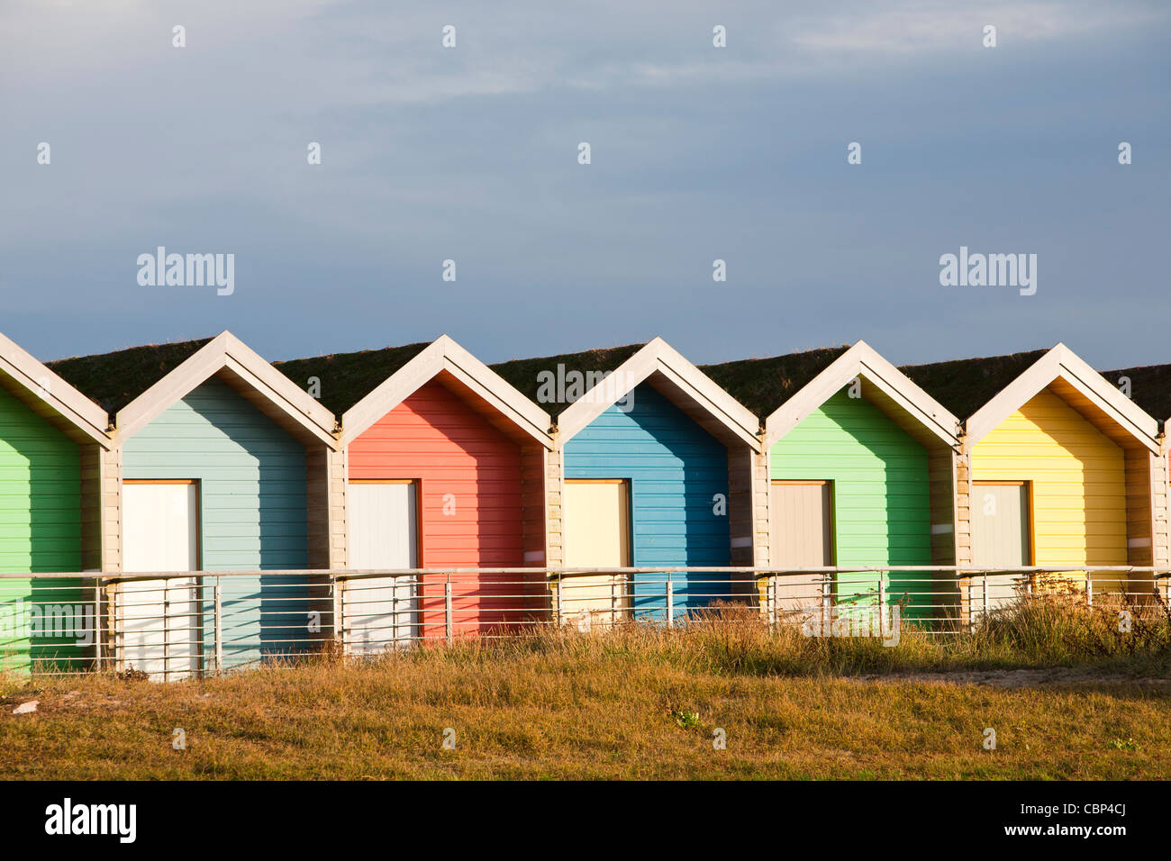 Colourful traditional British seaside beach huts on the beach in Blyth ...