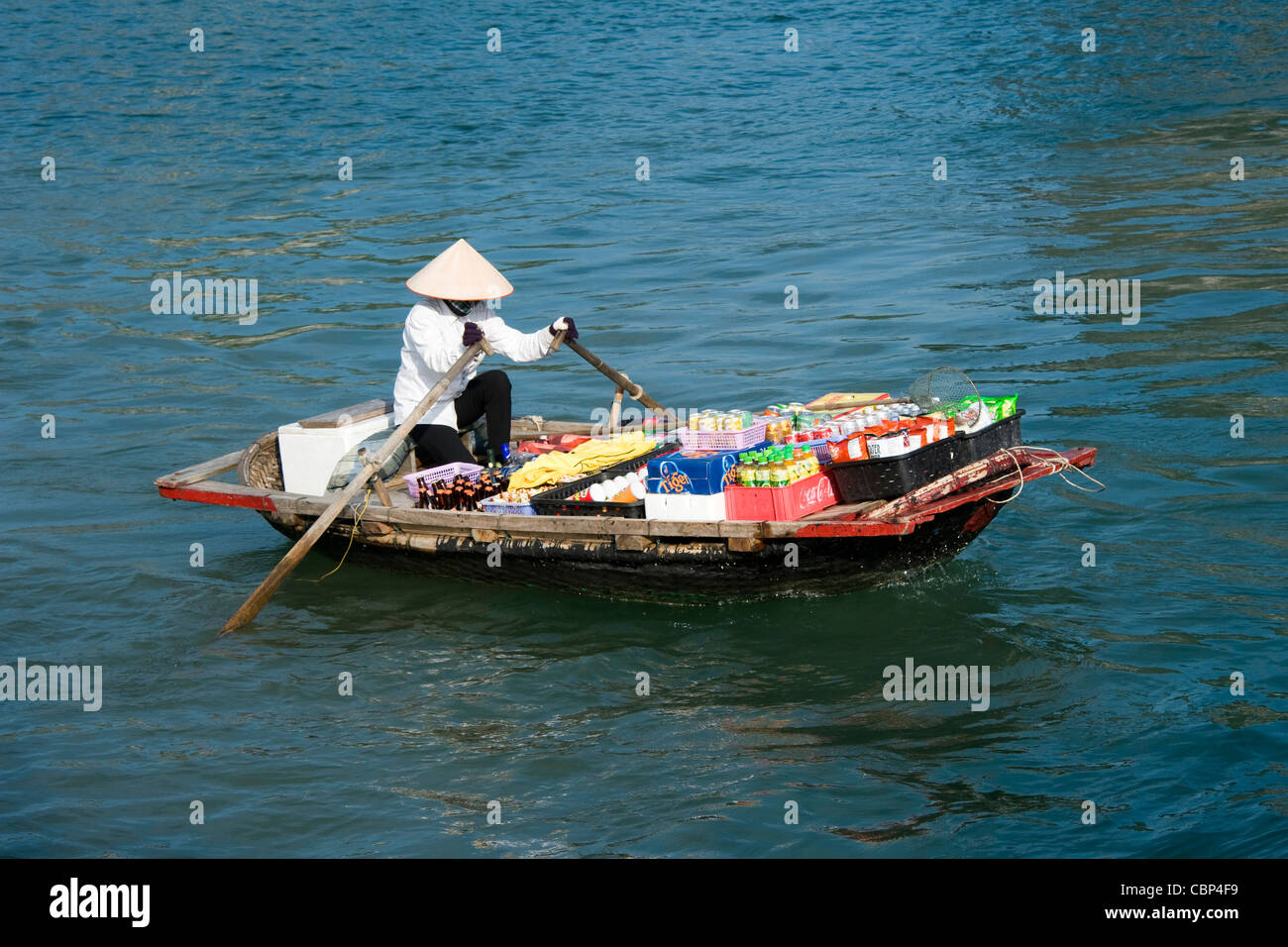 Lady paddling her floating shop from one barge to another Stock Photo ...