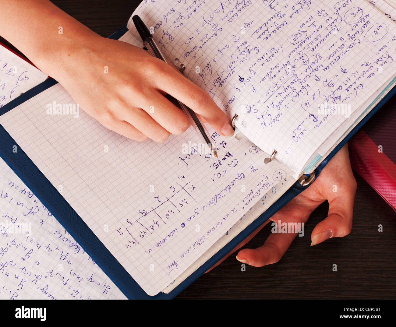 Student hands and notebook with pen at the desk Stock Photo - Alamy
