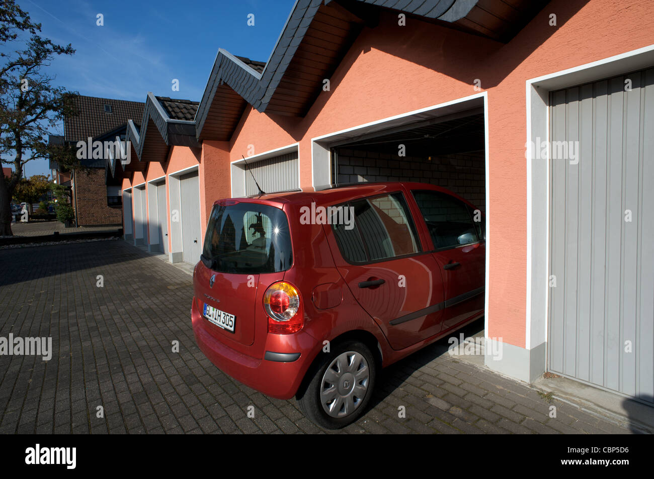 Car reversing out of garage Stock Photo - Alamy