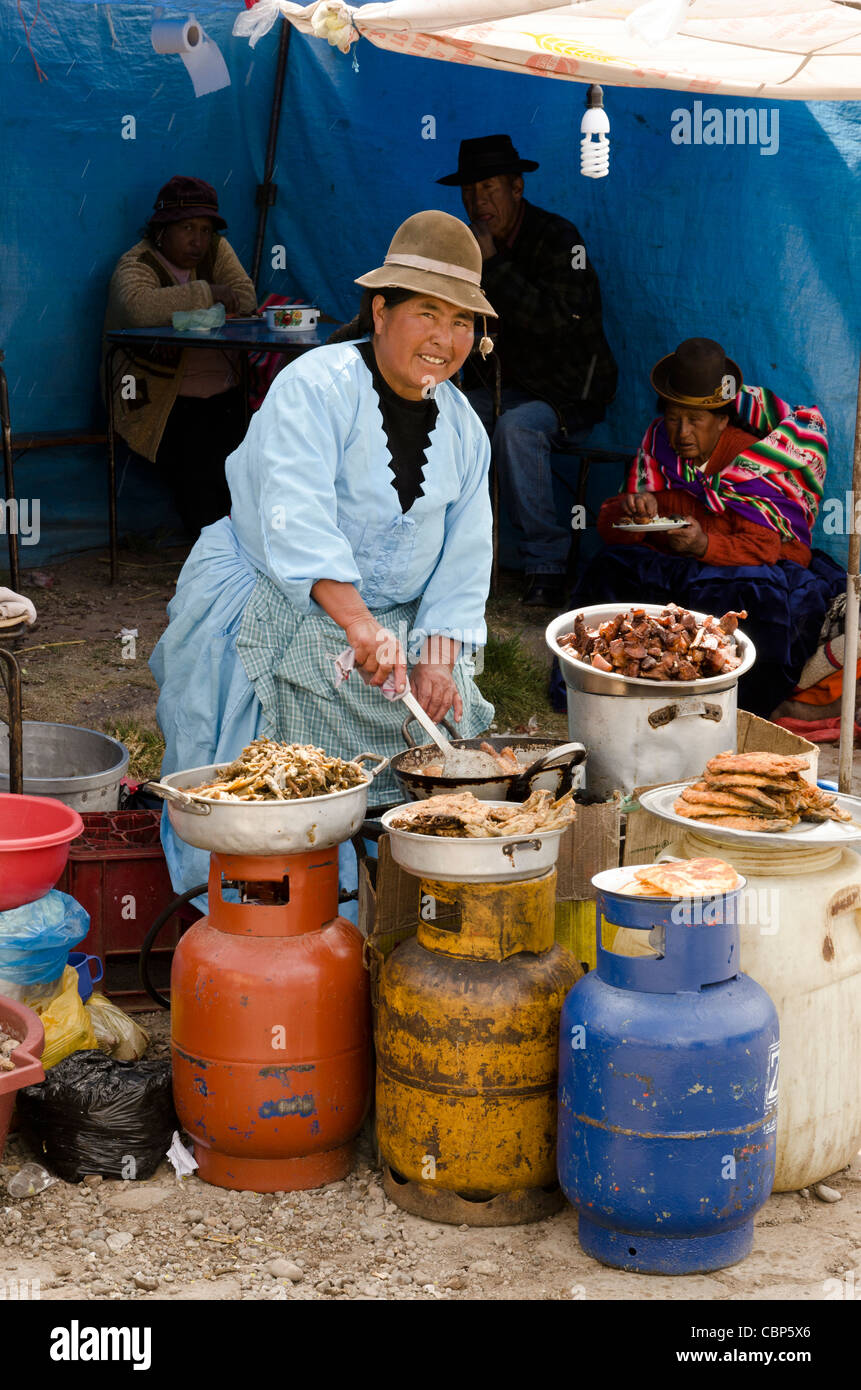 Woman cooking traditional food in the street Chucuito Puno Peru Stock ...