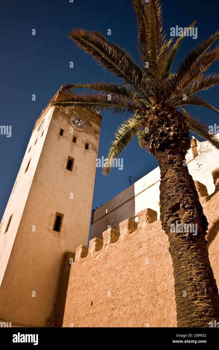 Clock tower and palm tree; Medina wall, Essaouira, Morocco Stock Photo ...
