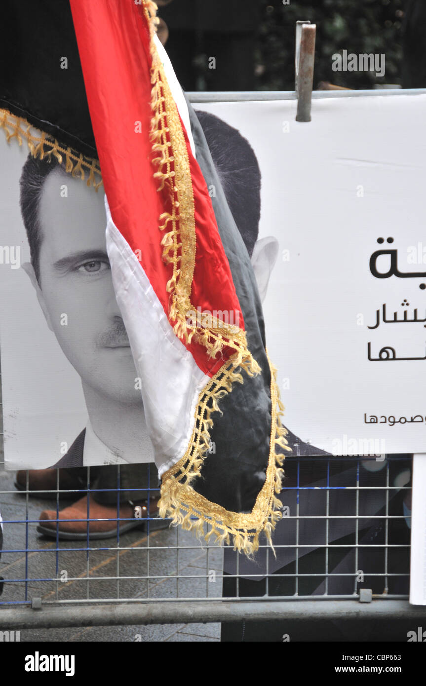 Bashar al-Assad President of Syria poster and flag at an anti Assad ...
