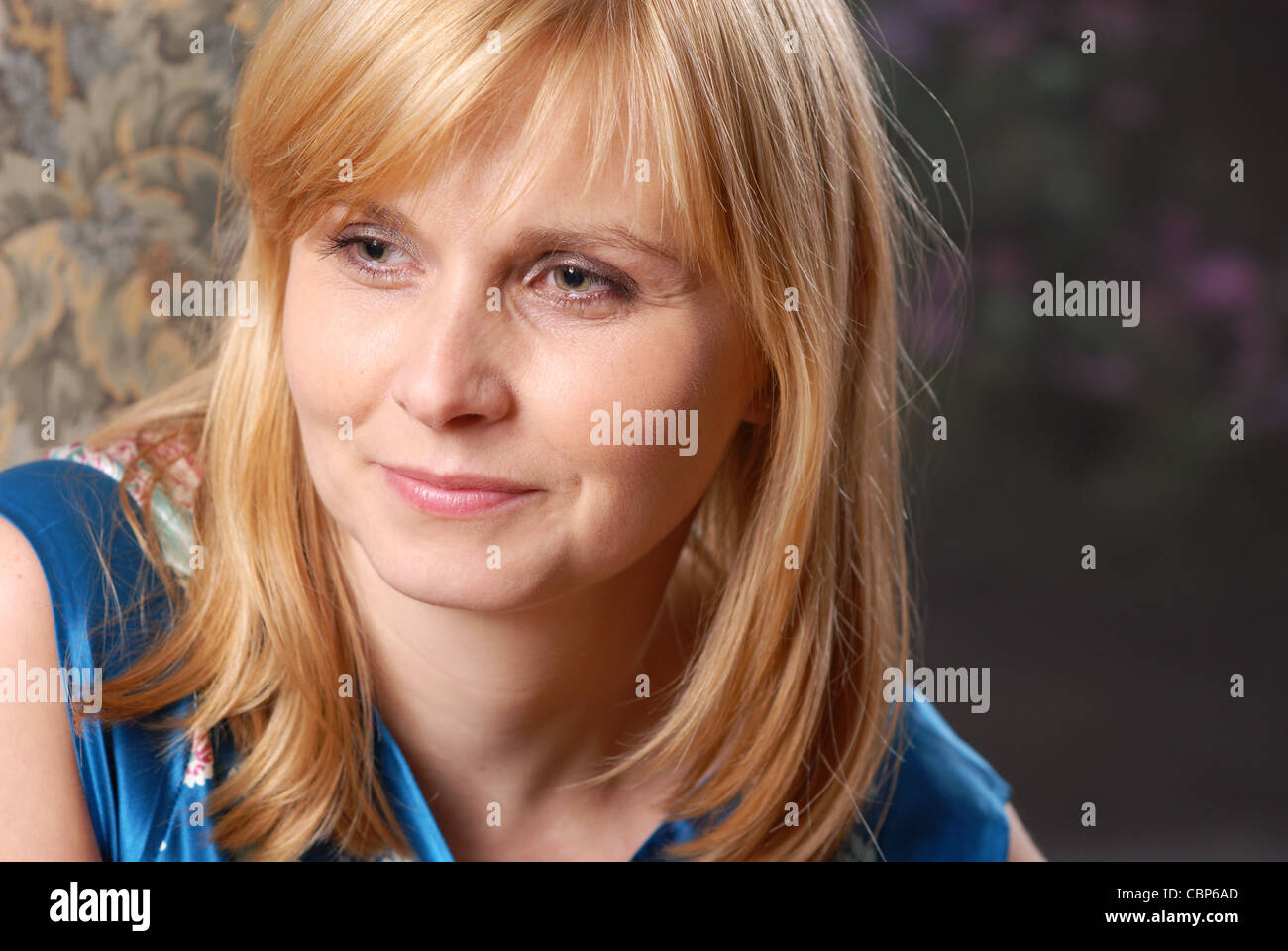 Natural portrait of attractive woman sitting on the chair Stock Photo ...