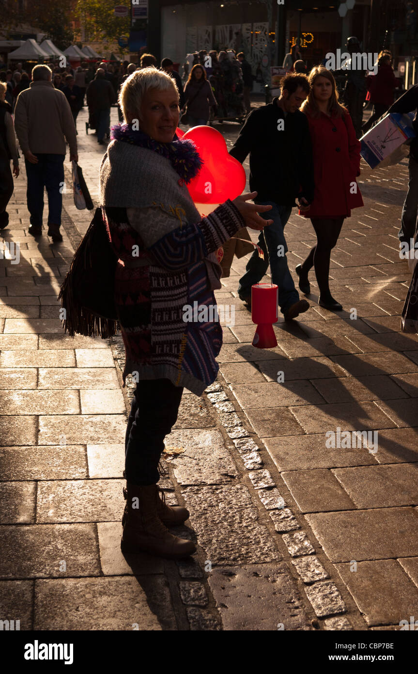 A strongly backlit picture of a woman collecting money for charity in ...