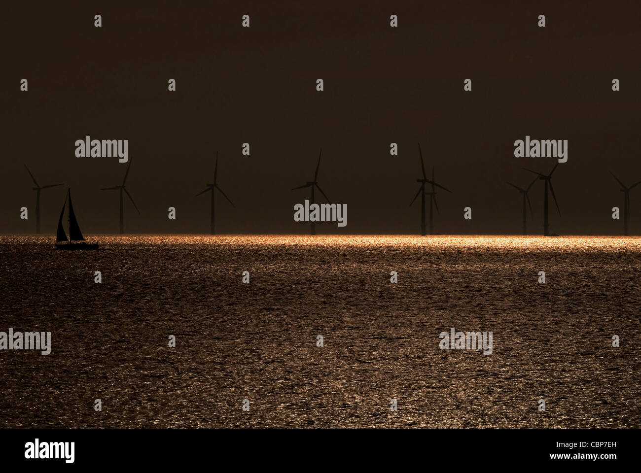 Wind Power, a yacht sails past the huge Gunfleet Sands offshore wind ...