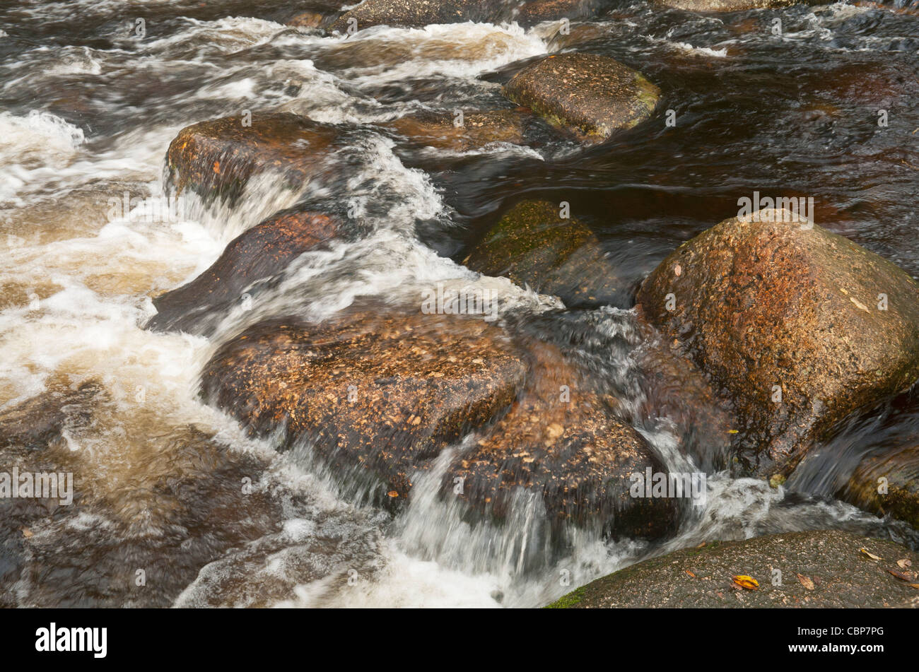 Water rushing over rocks in riverbed at East Dart river, Devon, UK ...