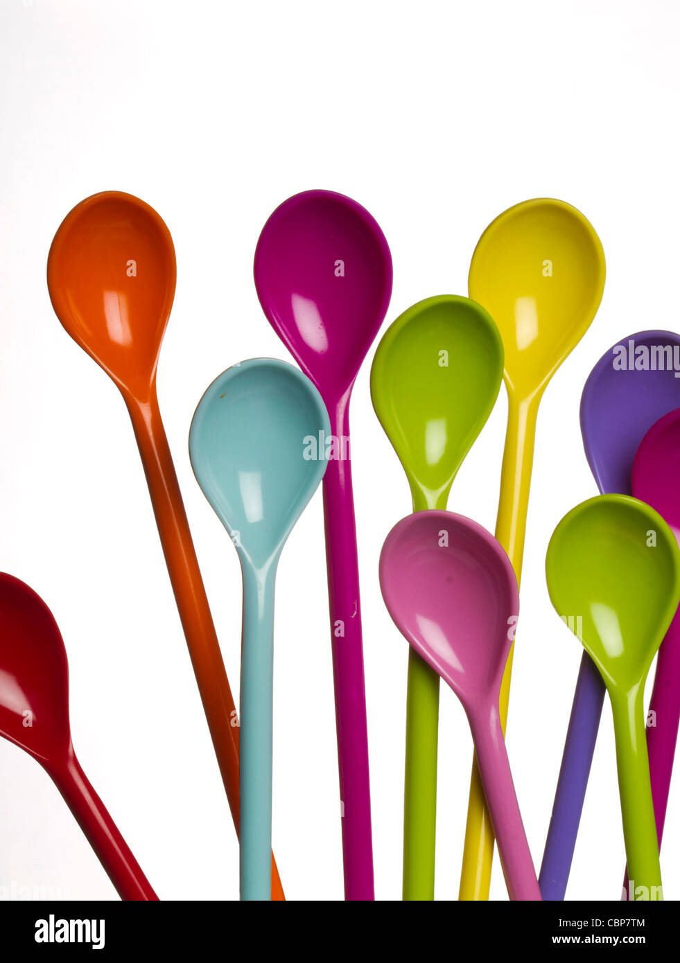 Spoons of different colors on even background Stock Photo - Alamy