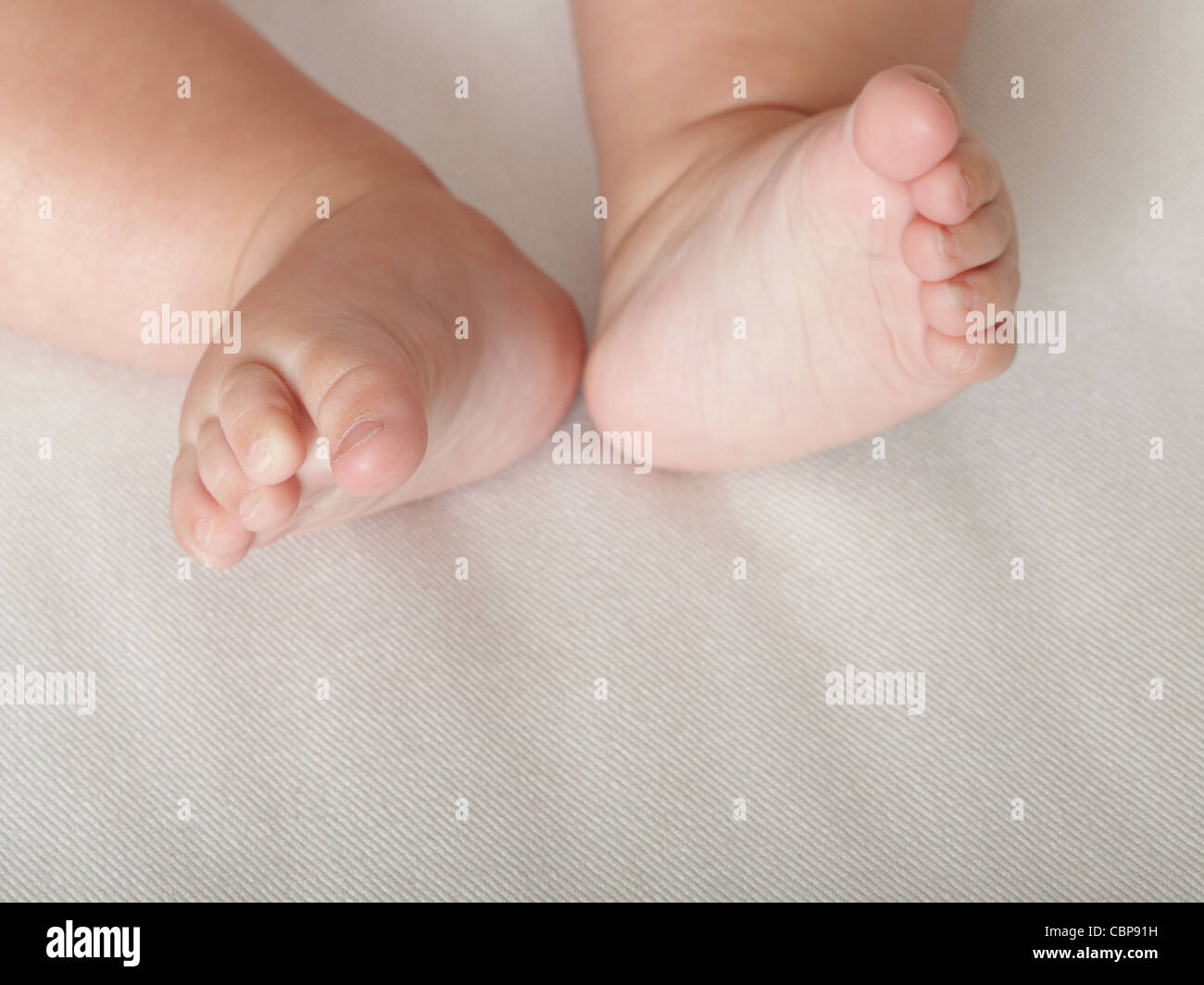Baby small toe foot on white background Stock Photo - Alamy