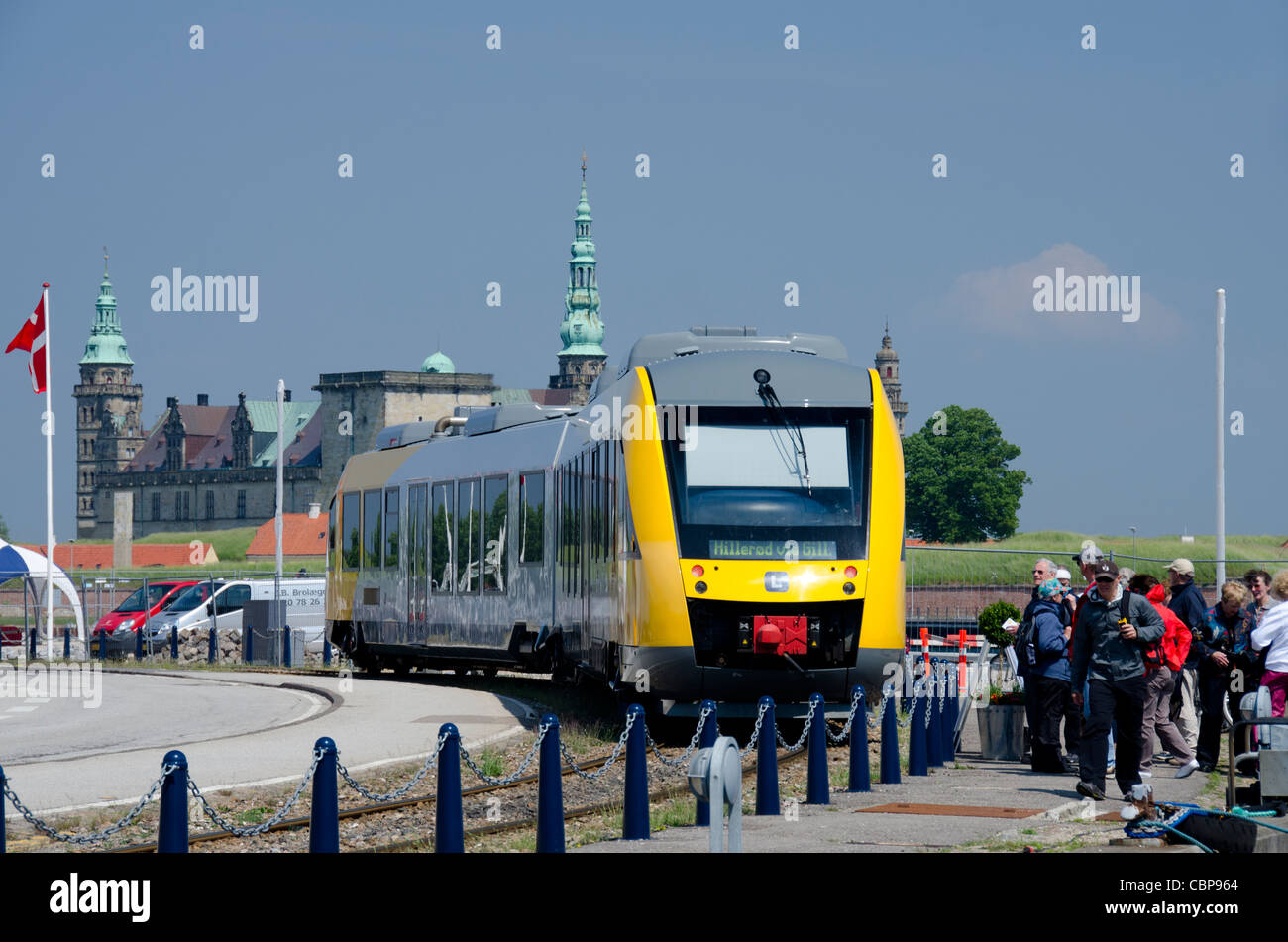 Denmark, Helsingoer. Downtown light rail tram with Kronborg Castle in ...