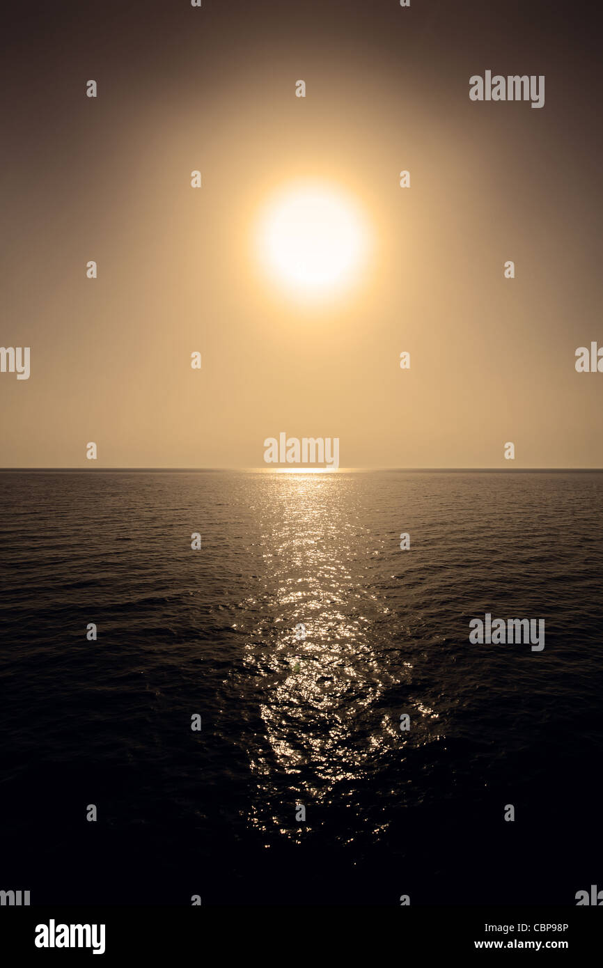 A sun above the sea horizon. Sepia toned image. Mediterranean, near ...