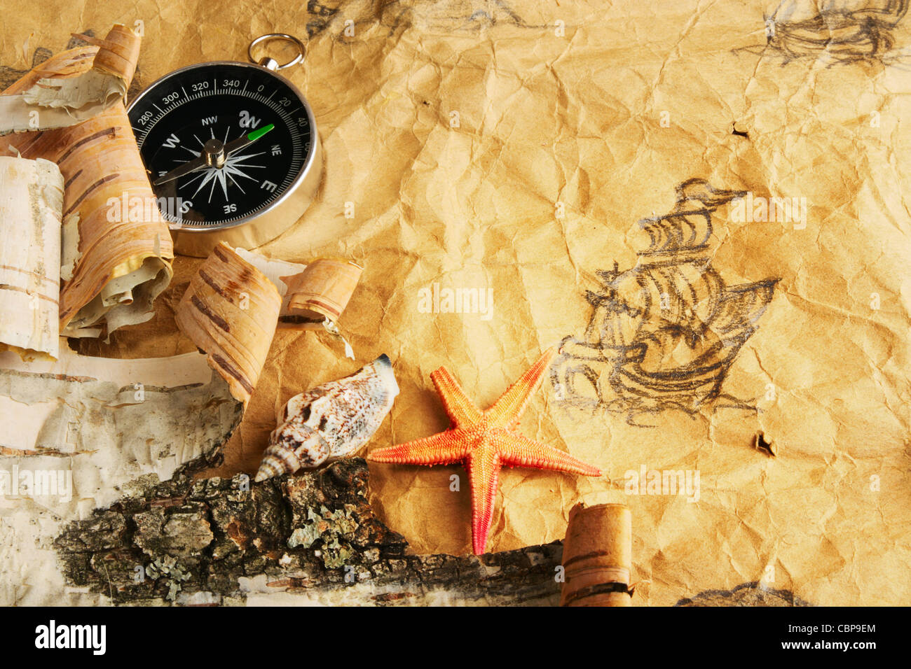 Still-life. Antique map, shell, starfish and compass Stock Photo - Alamy