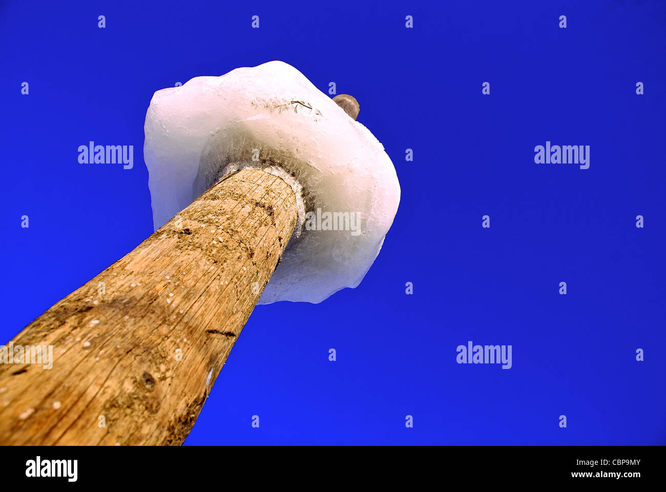 Pole with ice and blue sky Stock Photo - Alamy
