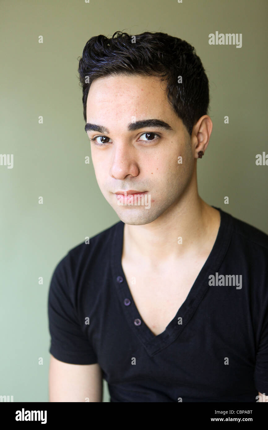 Handsome young man gives serious pose Stock Photo - Alamy