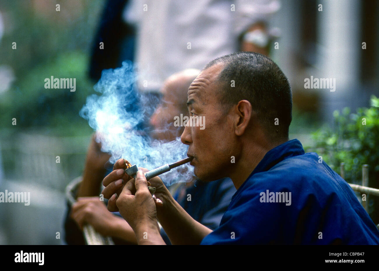 Man lighting pipe Xian Shaanxi China Stock Photo - Alamy
