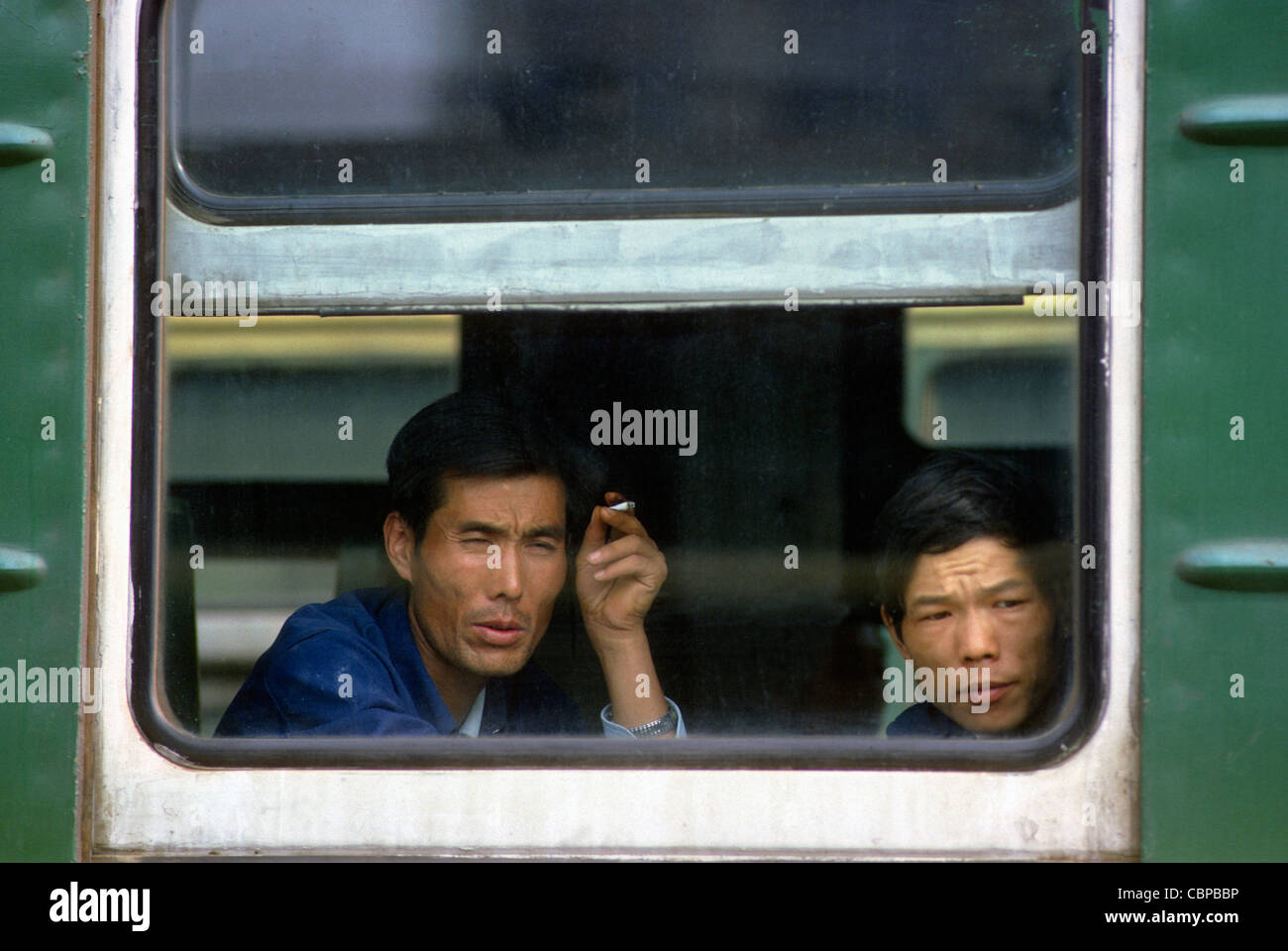 Two men in train carriage through window Xian Shaanxi China Stock Photo ...