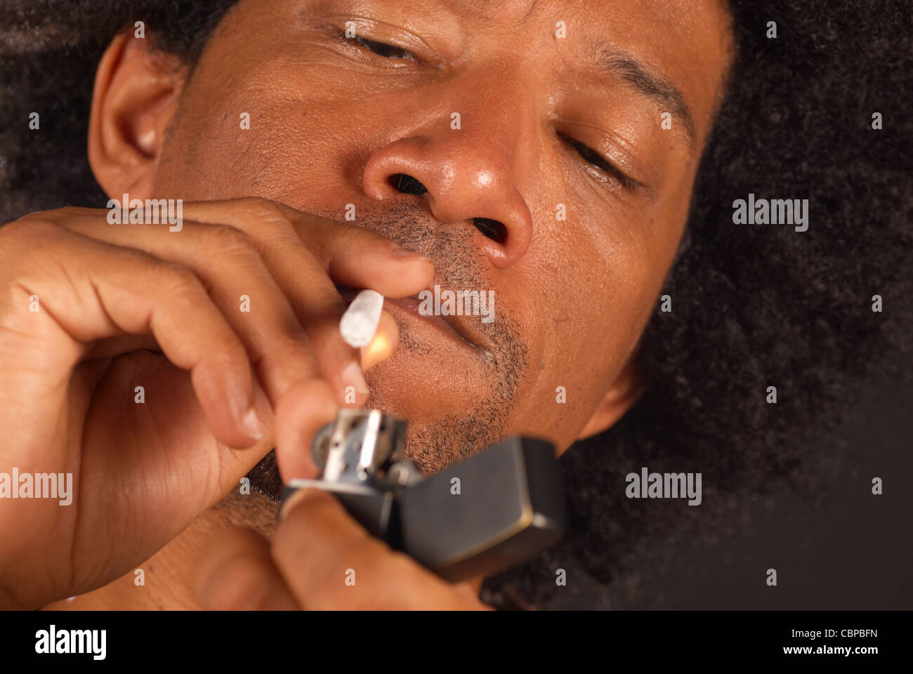 African american male about to light a spliff Stock Photo - Alamy