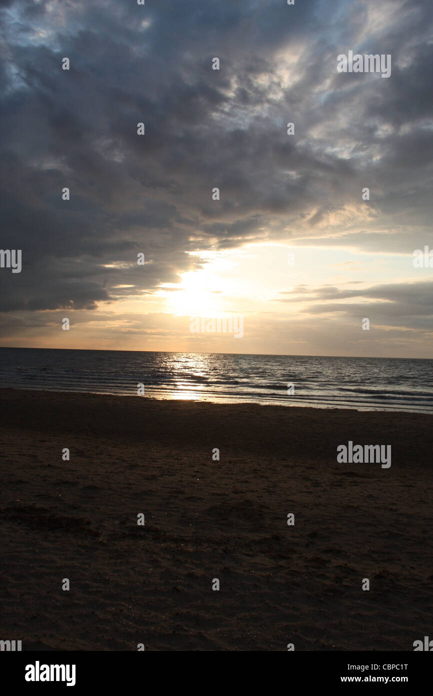 Sunset dark clouds dramatic seascape over beach Stock Photo - Alamy