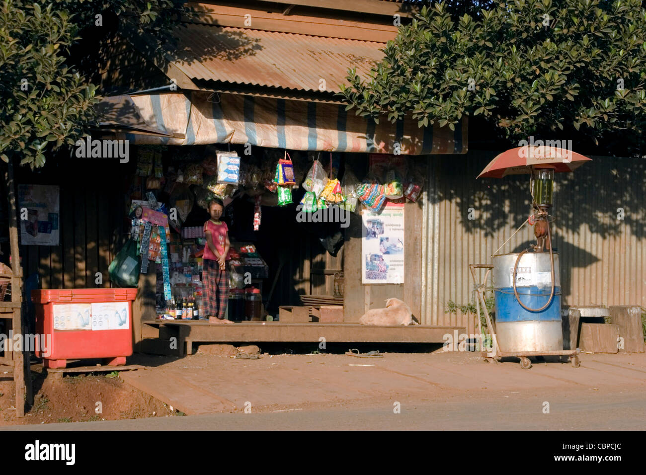 A young Asian girl is standing in a small store in Ban Lung, Cambodia ...