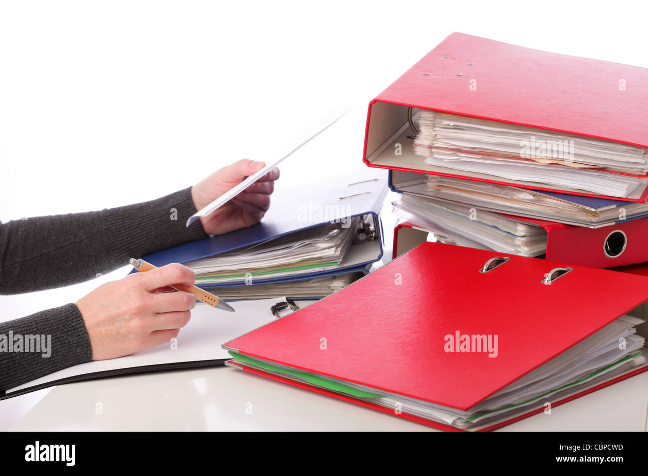 businesswoman - woman hand pen. Pile of folders with old documents and ...