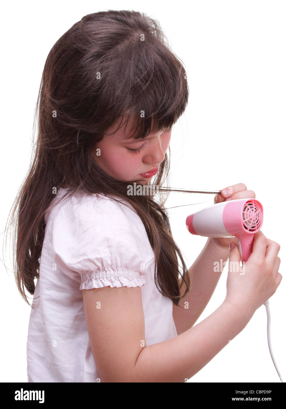 Pretty girl drying her hair hairdryer isolated on white Stock Photo - Alamy