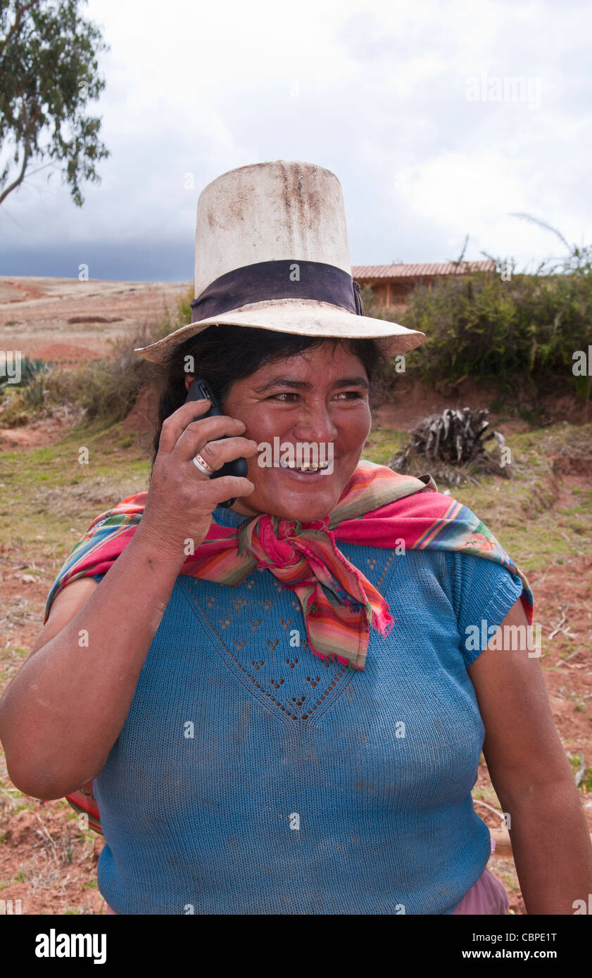 Wonderful farming woman on farm with cell phone in traditional dress ...