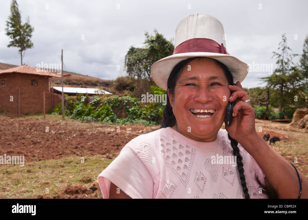 Wonderful farming woman on farm with cell phone in traditional dress ...