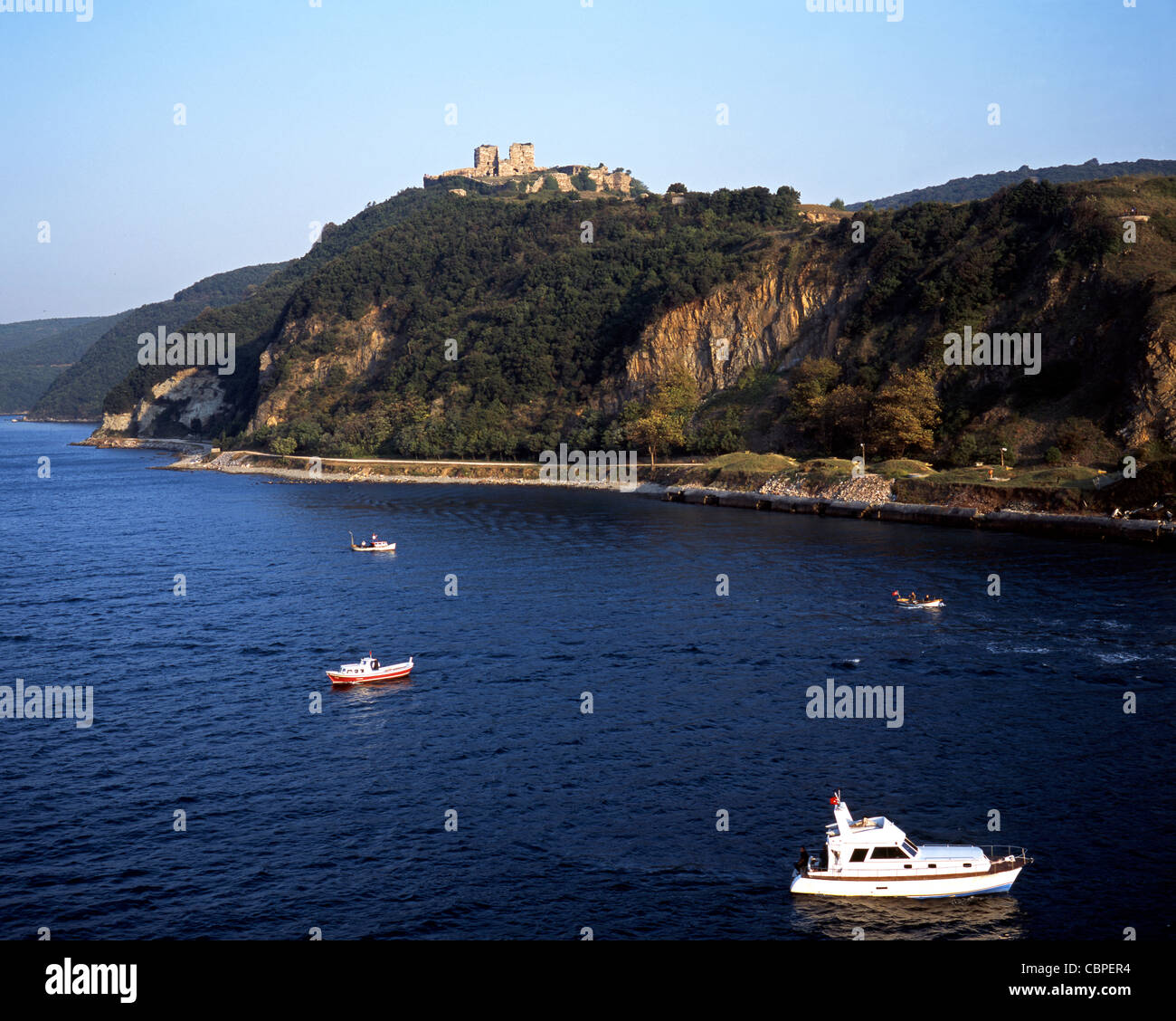 Castle on hillside with boats at anchor along the coast, Trabzon (Black ...