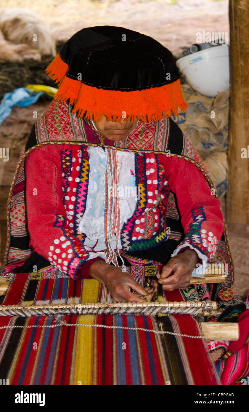 Local woman in the Sacred Valley Peru weaving with yarn in traditional ...