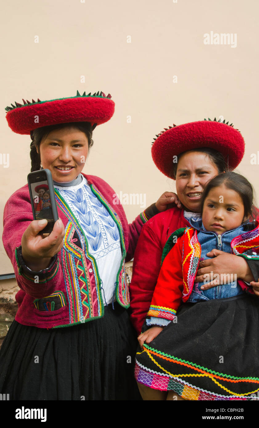 Modern life in Peru family in traditional dress and hat taking photo ...
