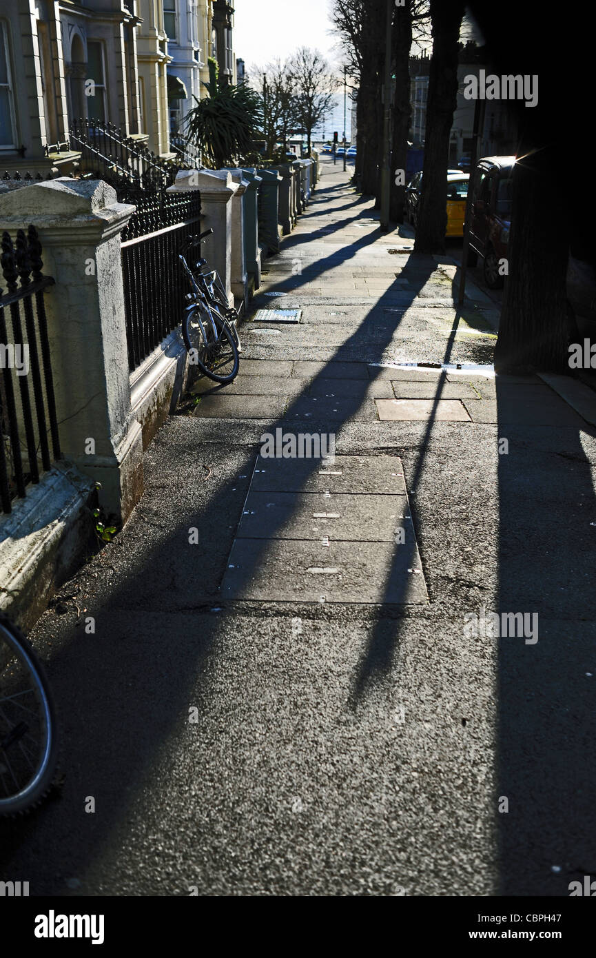 Long shadows on a pavement Brighton UK Stock Photo - Alamy
