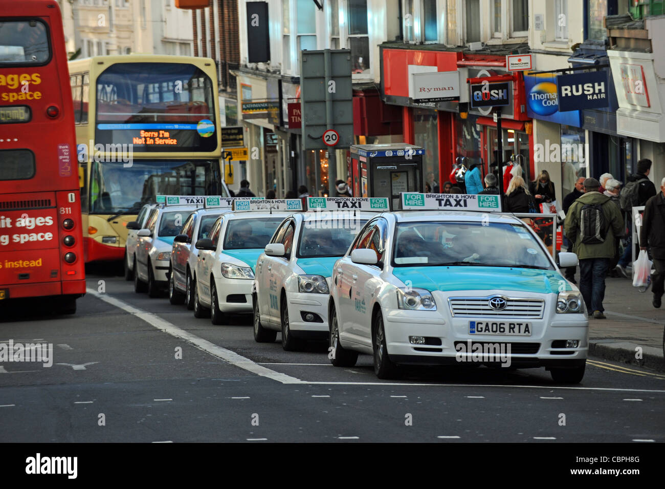 Queue of taxi cab vehicles waiting at traffic lights in North Street ...