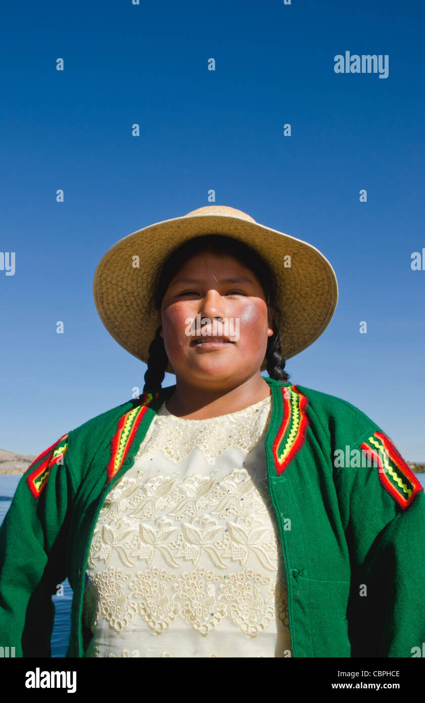 Portrait of young woman in Uros family on floating islands of Lake ...