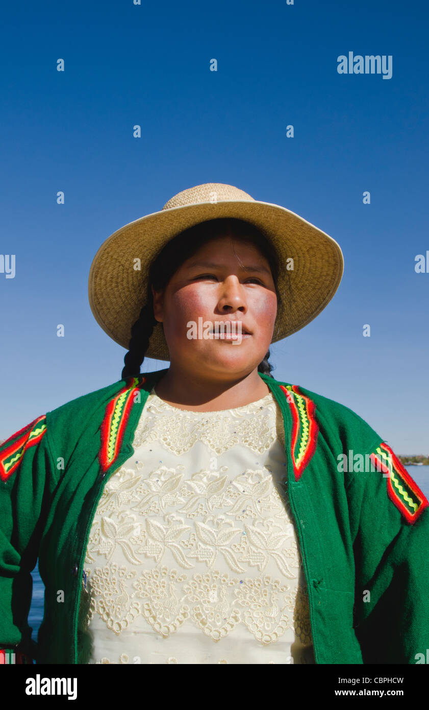Portrait of young woman in Uros family on floating islands of Lake ...
