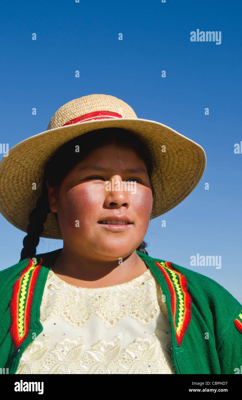 Portrait of young woman in Uros family on floating islands of Lake ...